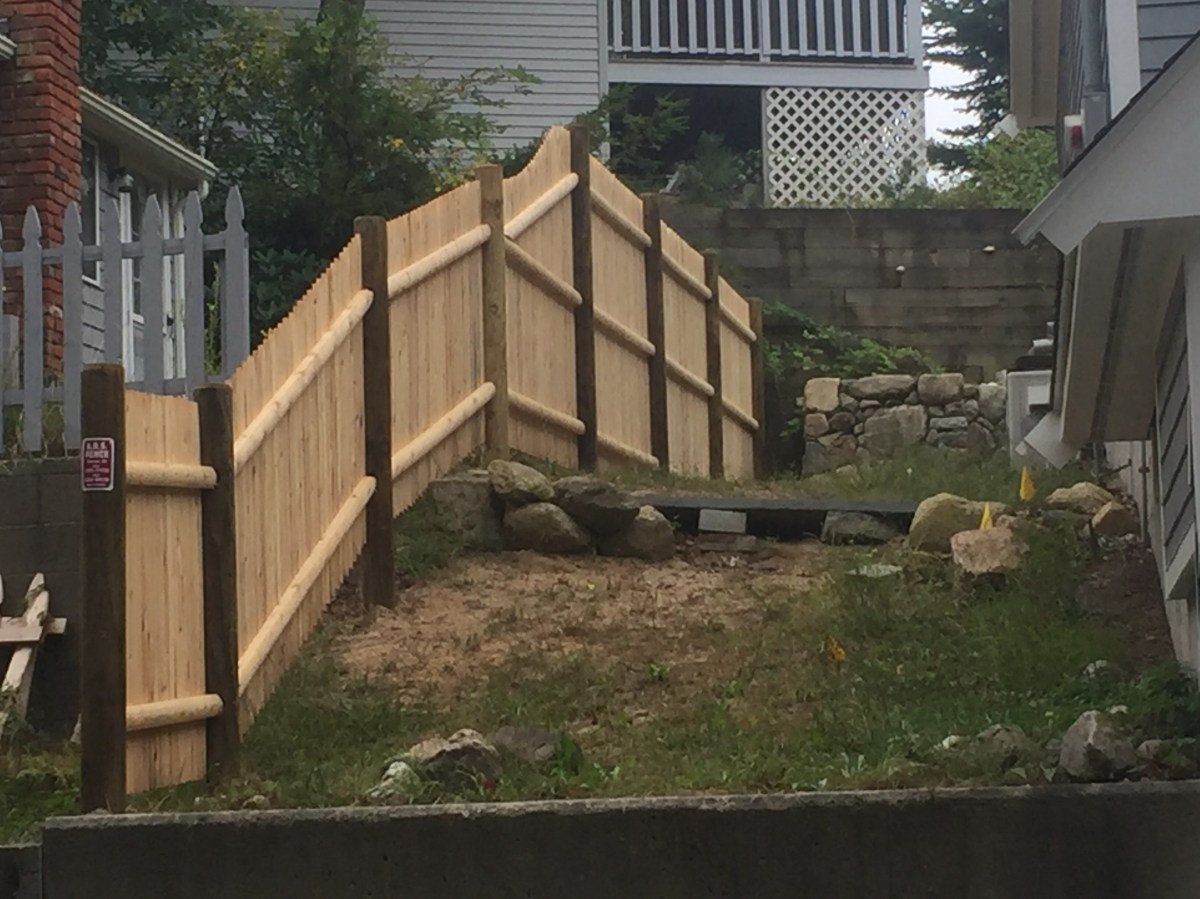 Cedar Stockade on a Retaining Wall | ABS Fence Inc.